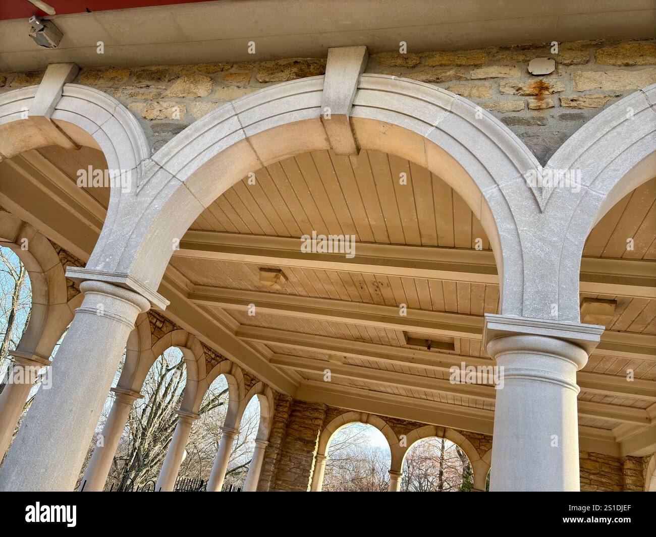 Arched stone columns and detailed masonry under a pavilion roof Stock ...