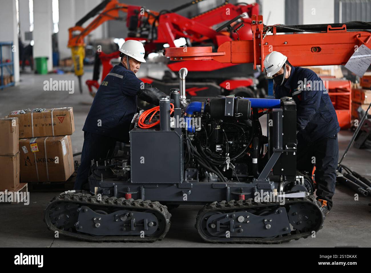 Chuzhou, China. 03rd Jan, 2025. Workers assemble all-terrain four-drive ...
