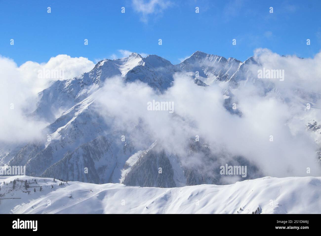 Austrian Alps landscape in winter. Mountains hidden in clouds in ...