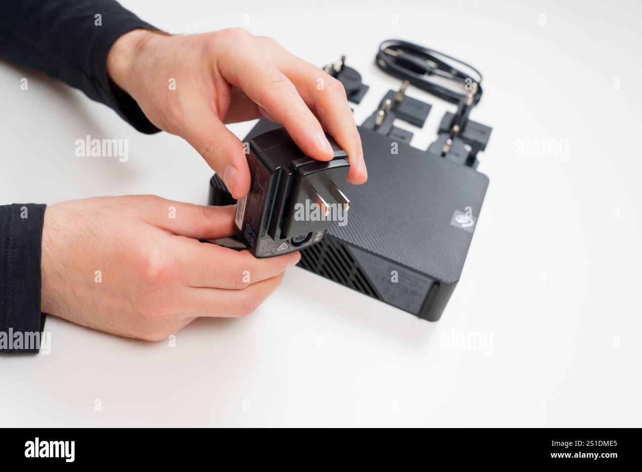 Kyiv, Ukraine - October 23, 2024: Hands removing the plug from the ...