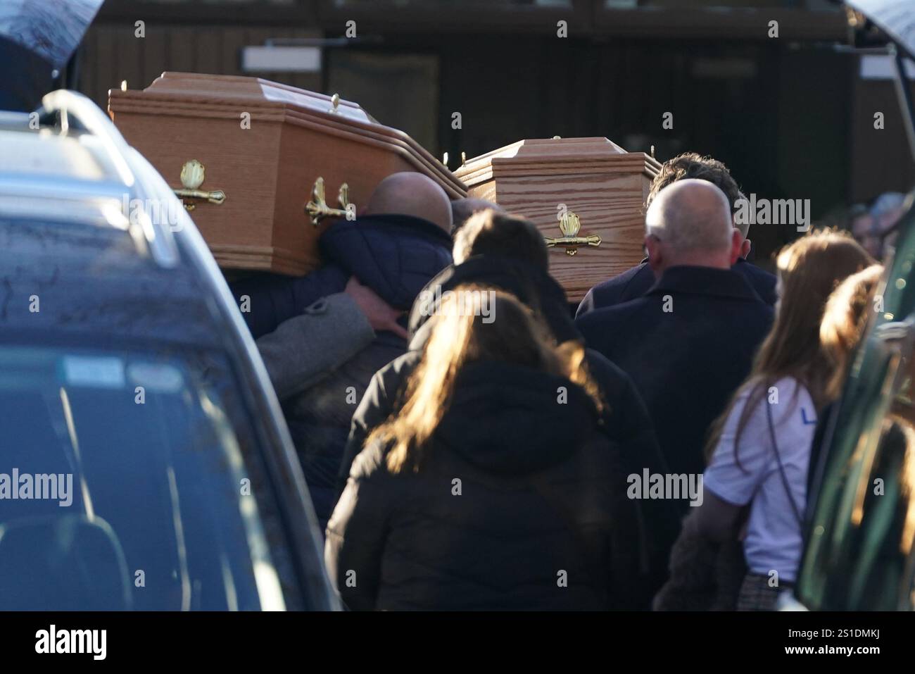The coffins of husband and wife Anthony and Georgina Hogg are carried ...