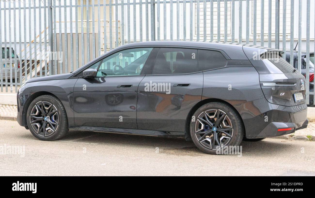 Modern electric bmw ix suv parked on a street near a metal fence Stock ...