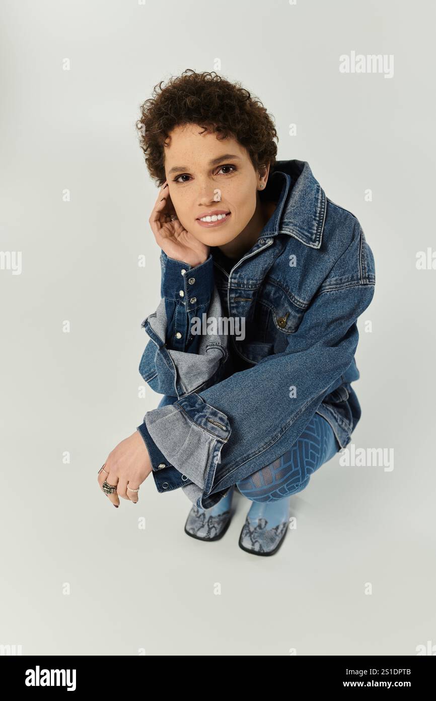 A vibrant young woman showcases her unique fashion sense while posing ...