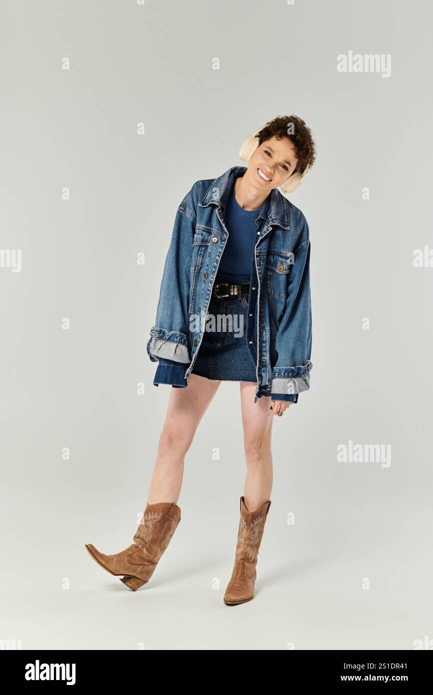 A confident young woman models a chic oversized denim jacket, skirt ...
