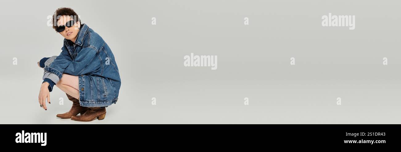 A confident young woman expresses her unique style while crouching in a ...