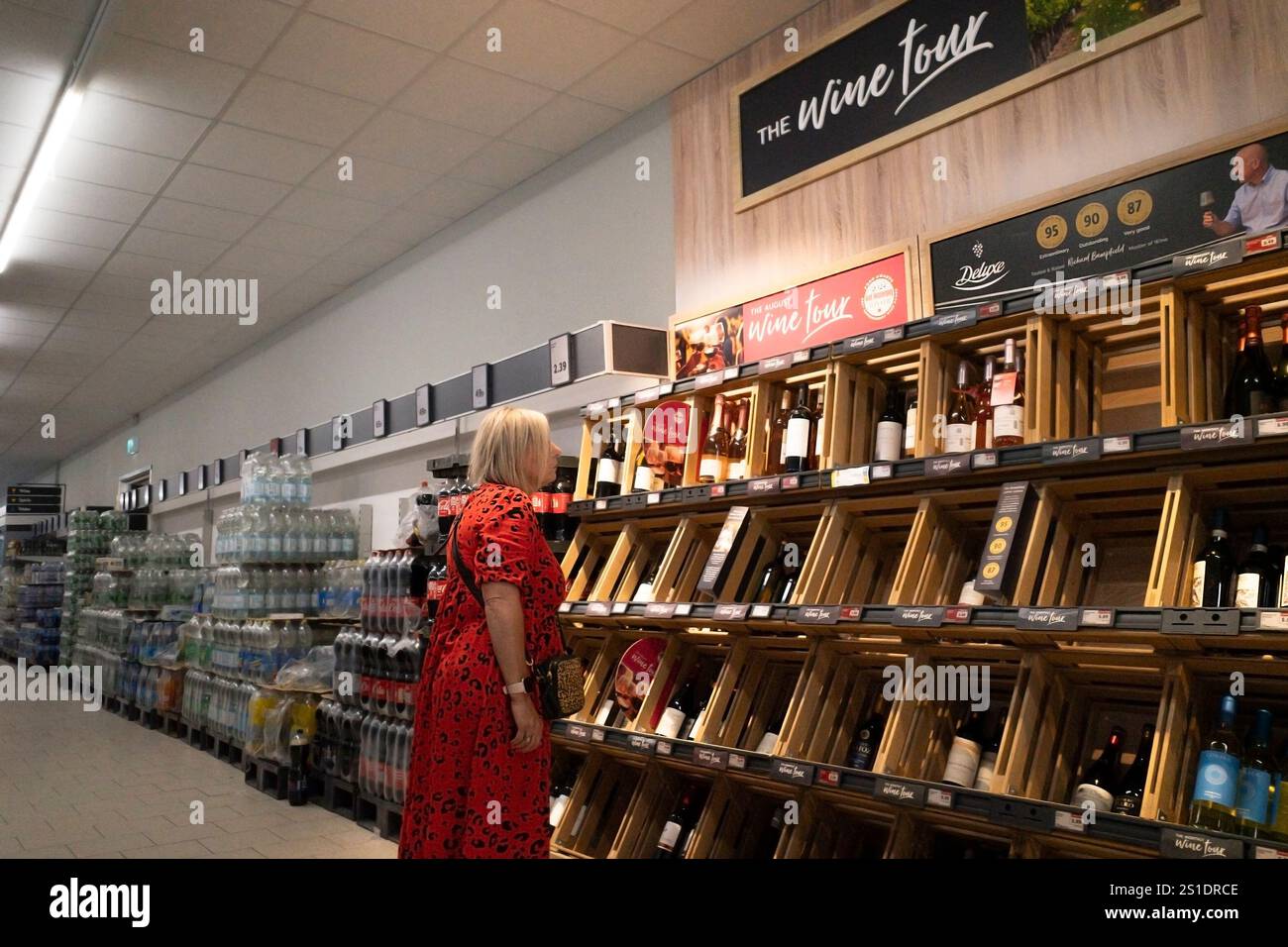 A shopper customer persone shopping inside a Lidl shop store in England ...
