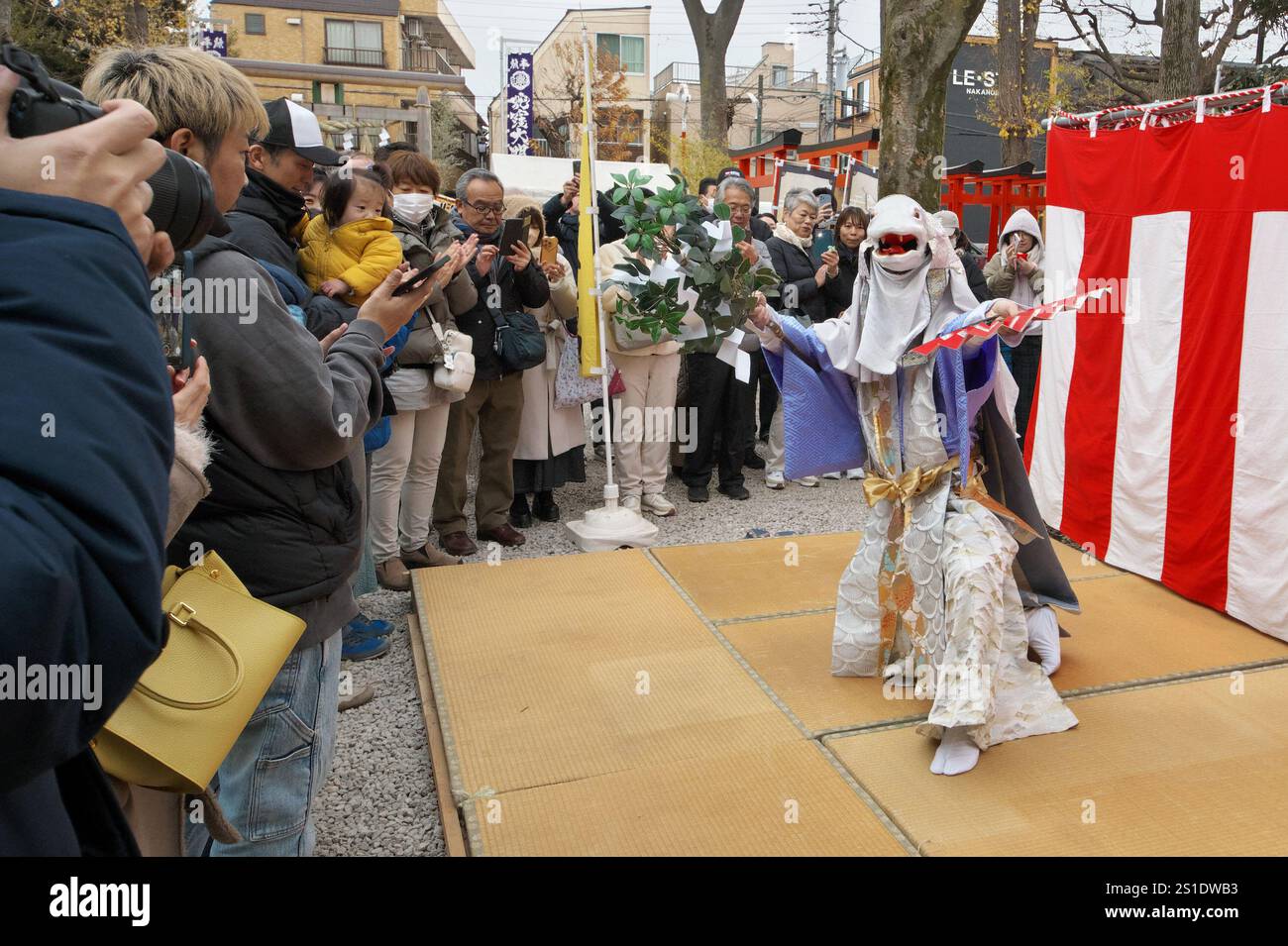 Performer wearing a white snake mask performs at the Hebikubo Shrine in ...
