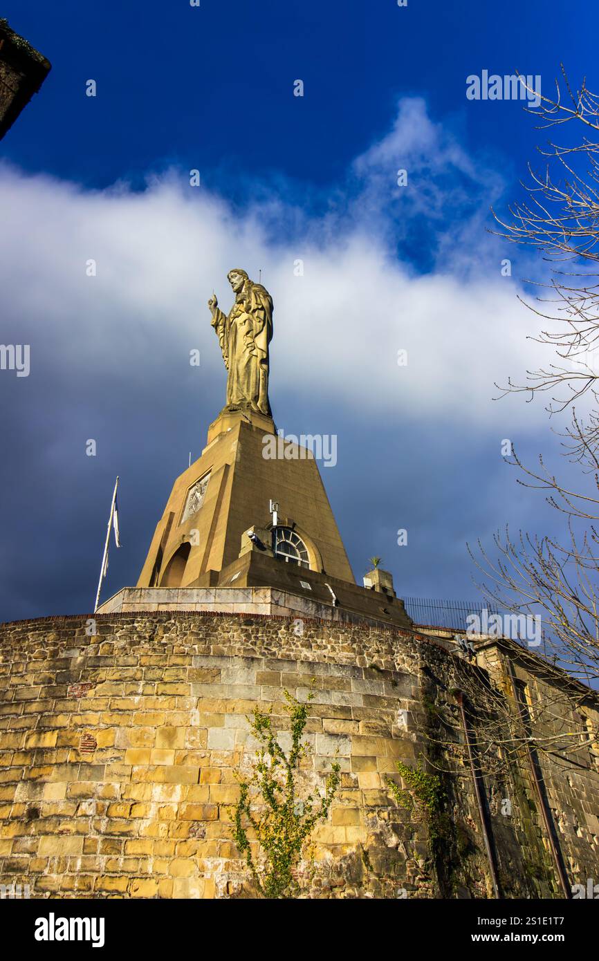 Close-up view of the Cristo de la Mota statue atop Monte Urgull with dramatic sky in San ...