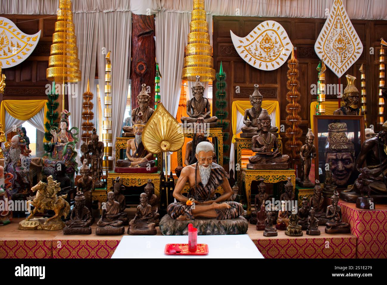 Ancient hermit or antique eremite statue with naka guardian of Wat Rat ...