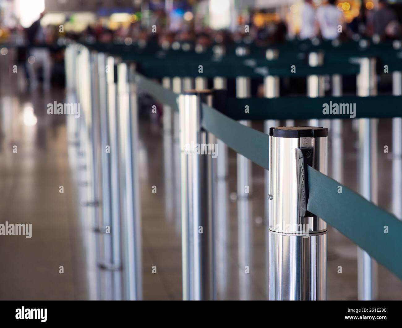 Stanchions with retractable belts for crowd control in a busy airport ...