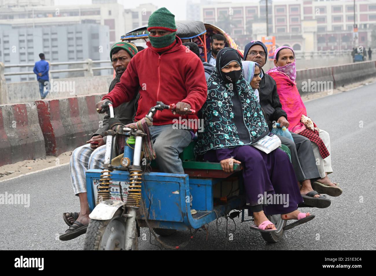 People are wearing winter clothes as they moves on the street due to ...
