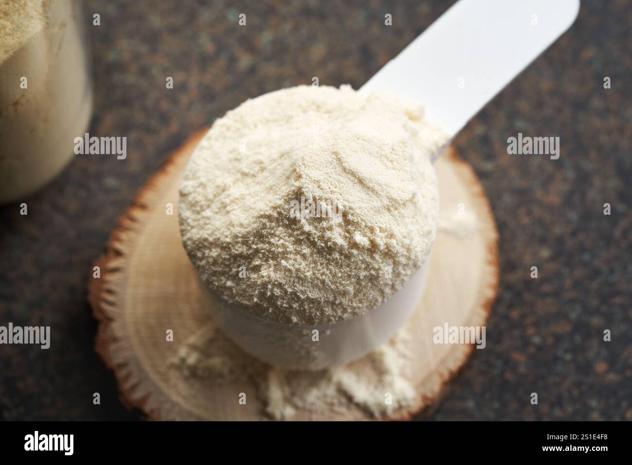 Whey protein powder in a plastic measuring cup, closeup Stock Photo - Alamy