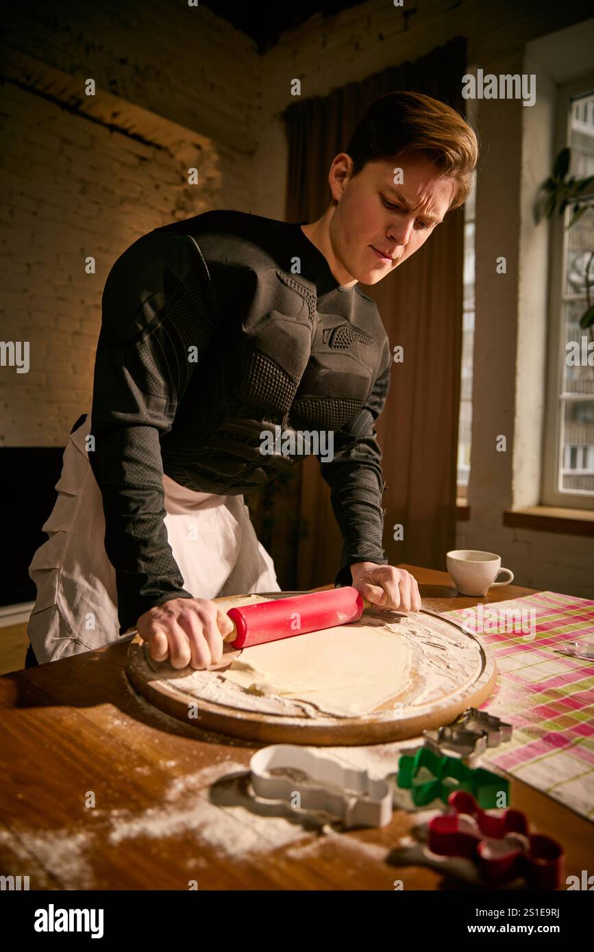Close up portrait of man, dressed superhero costume, carefully pressing ...