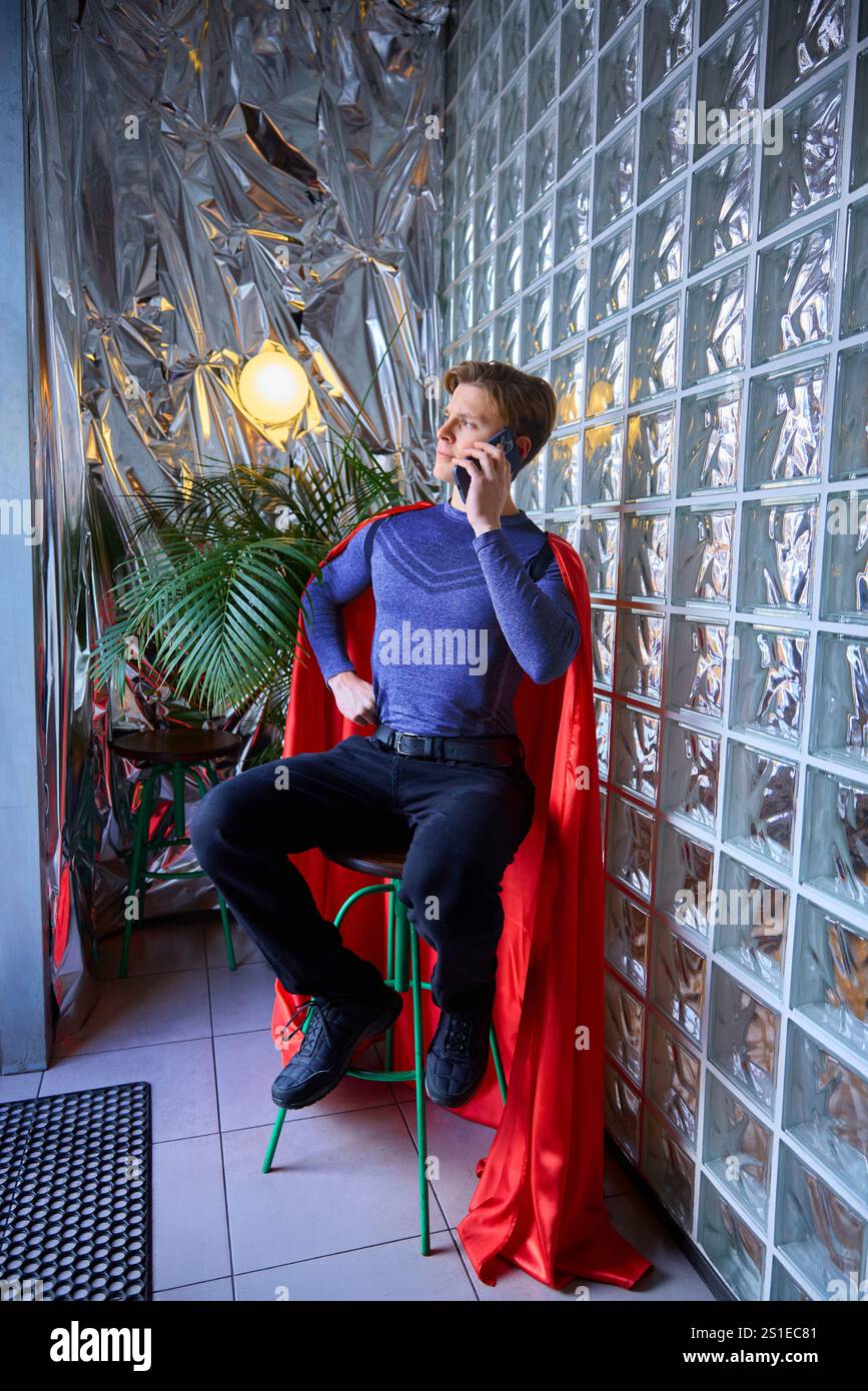Superhero-themed man strikes confident pose mid-call, connecting to ...