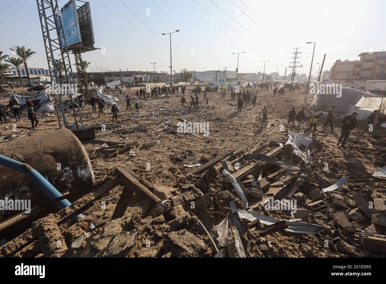 Palestinian inspect the rubbles of a factory destroyed by Israeli air ...