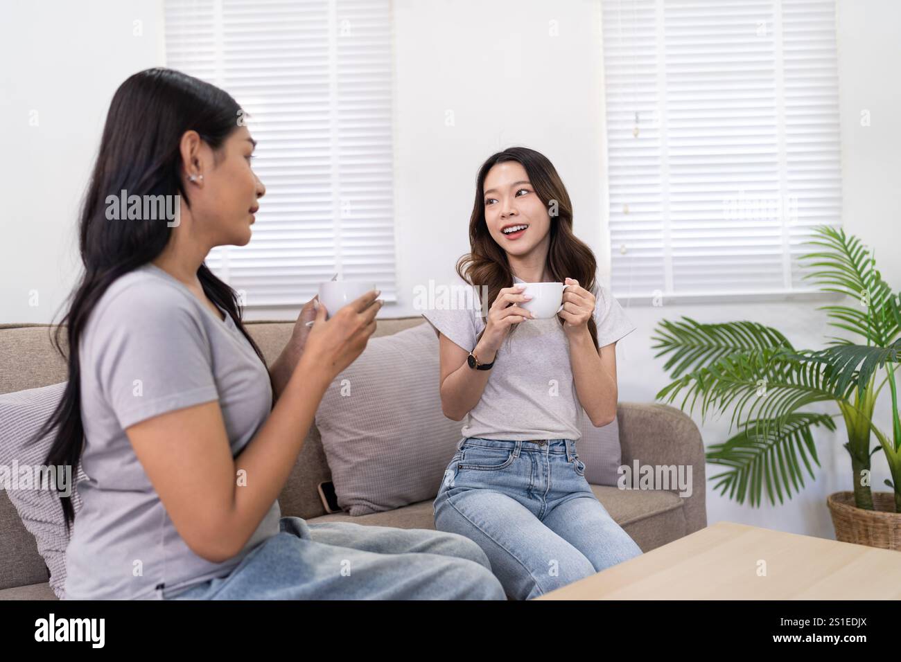 Two friends enjoying coffee together, engaging in a pleasant ...