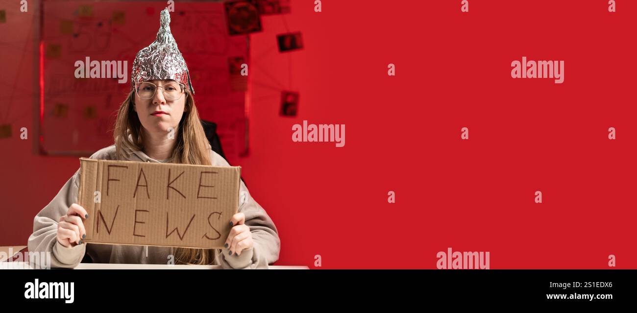 Female conspiracy theorist in protective foil cap and glasses debunks ...