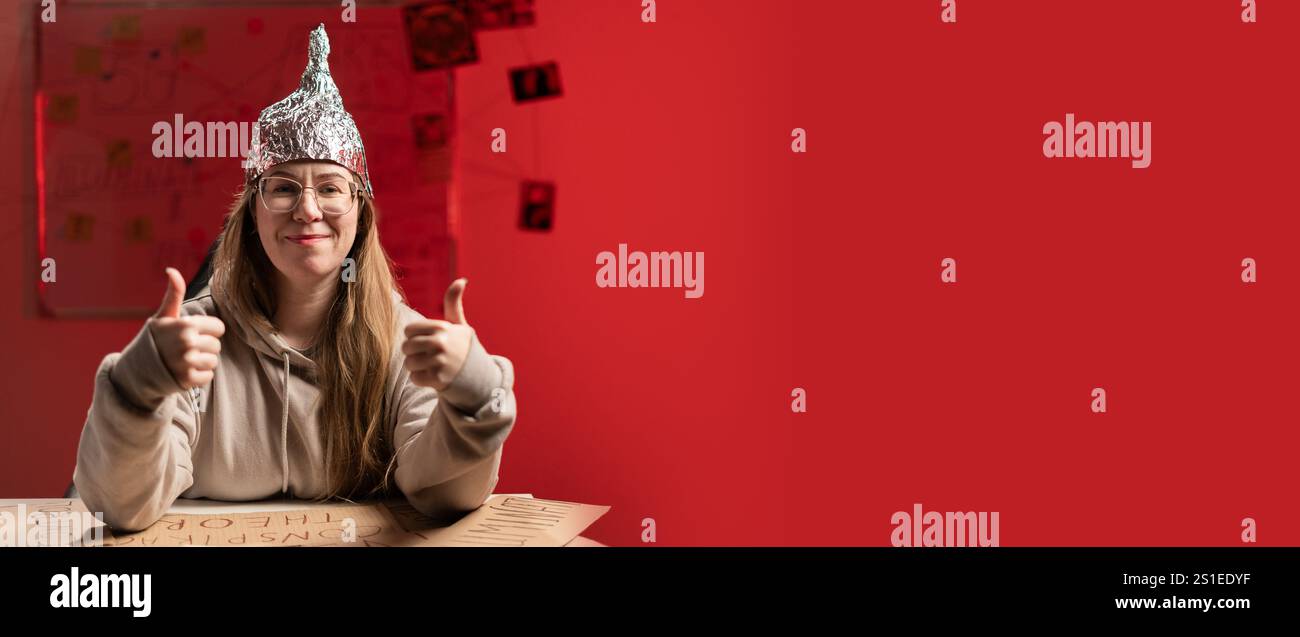 Female conspiracy theorist in protective foil cap and glasses debunks ...