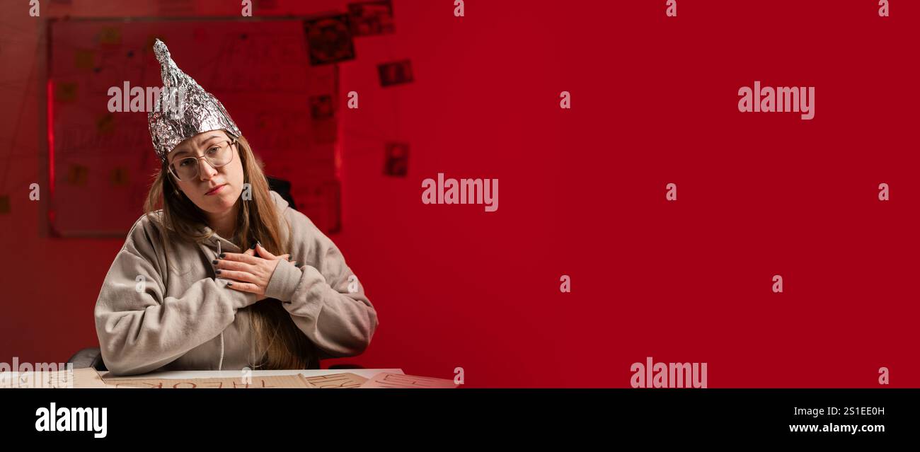 Woman wearing glasses in foil hat showing heart love emotion putting ...