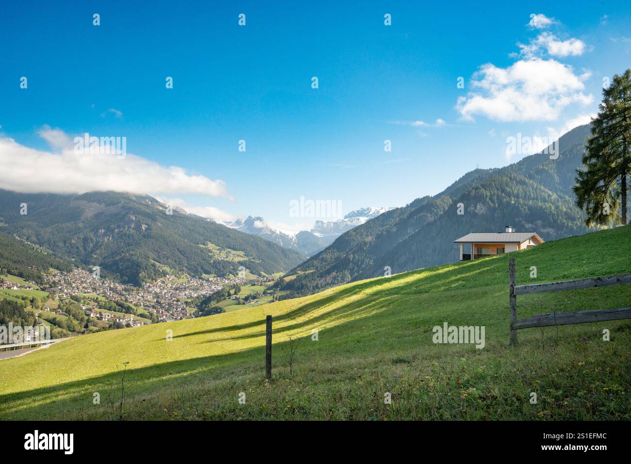 View of the Italian Alps Dolomites with traditional town architecture ...