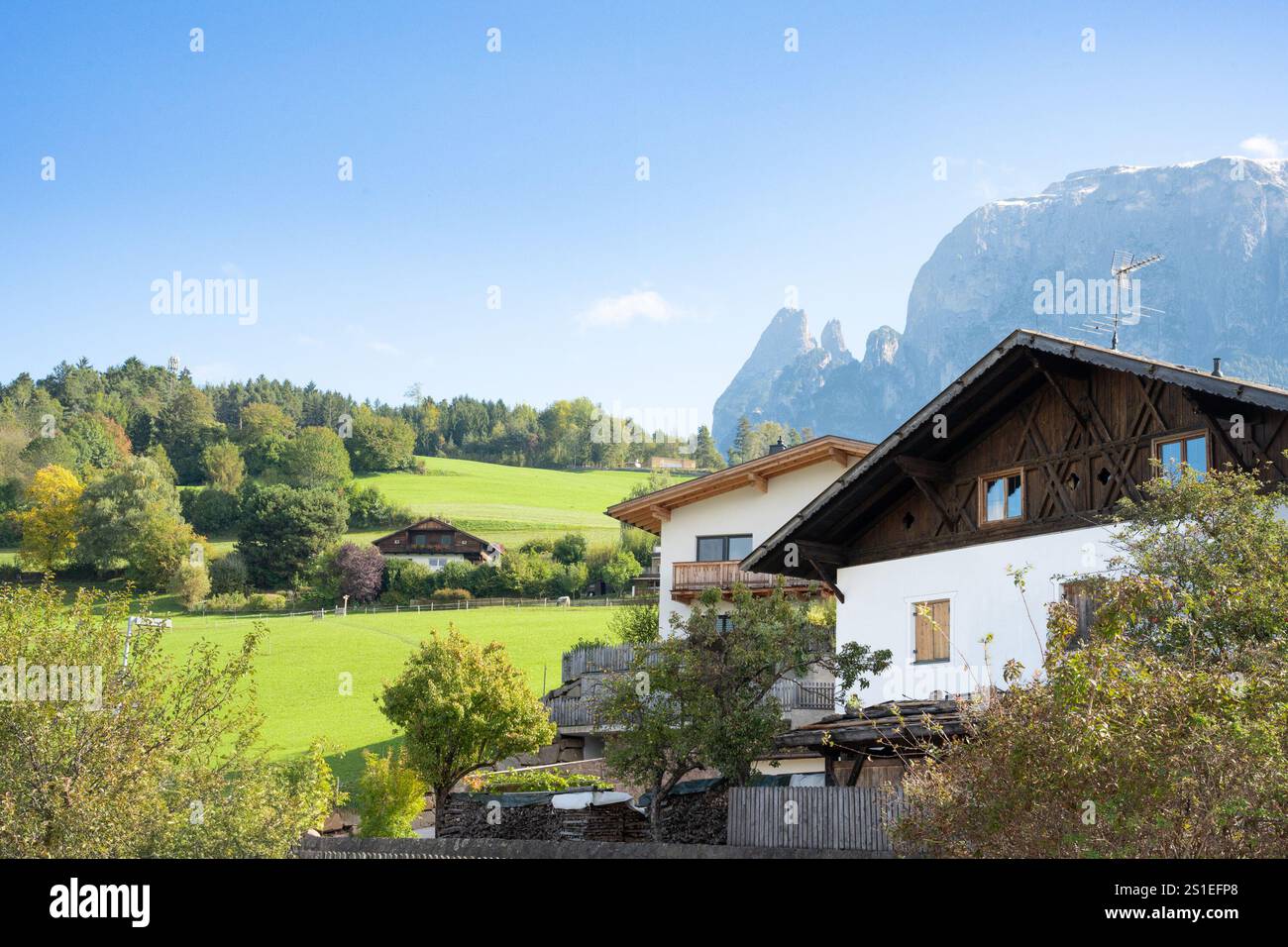View of the Italian Alps Dolomites with traditional town architecture ...