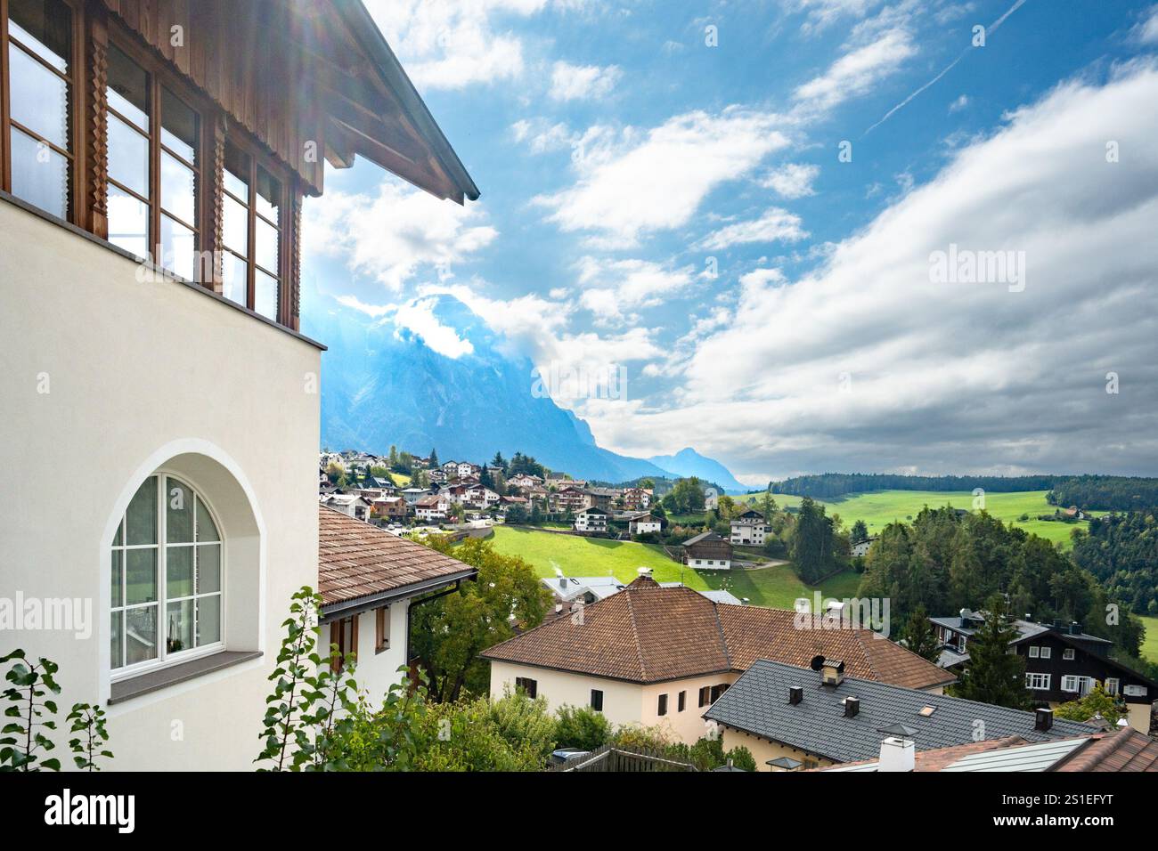 View of the Italian Alps Dolomites with traditional town architecture ...