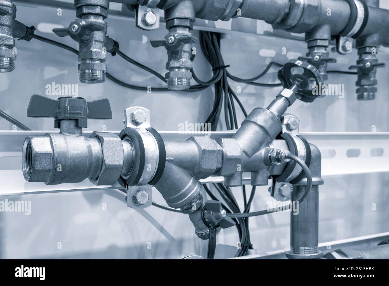 pipes and faucet valves of heating system in a boiler room Stock Photo ...