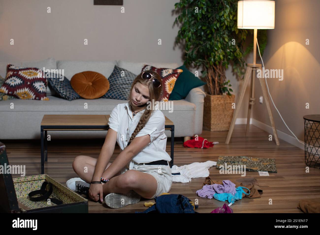 An untidy room featuring a young individual actively organizing their ...