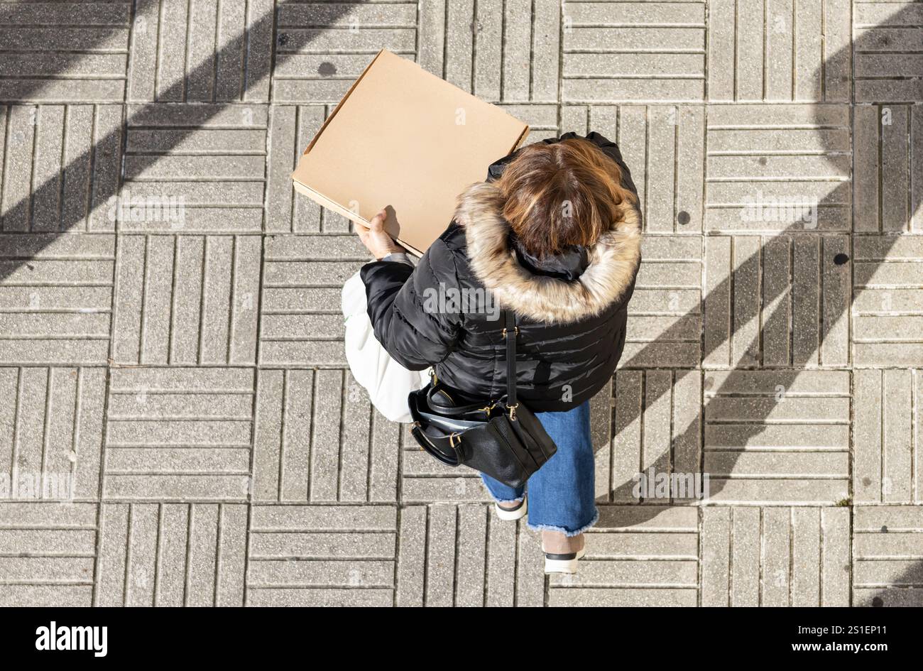 Top view of a Woman bringing home a pizza box with blank cardboard ...