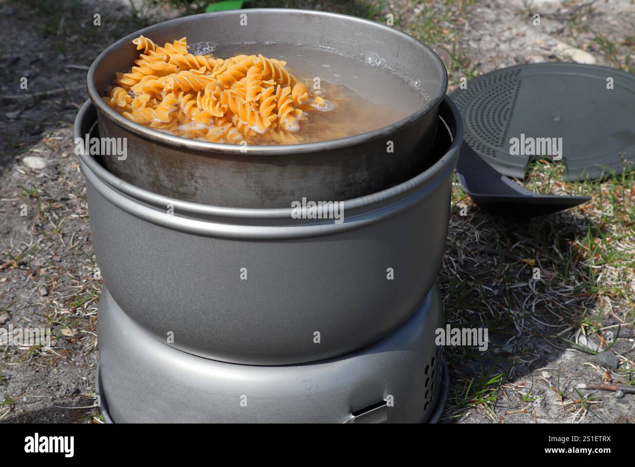 Cooking lunch outside. Boiling water and pasta. Camping and hike ...