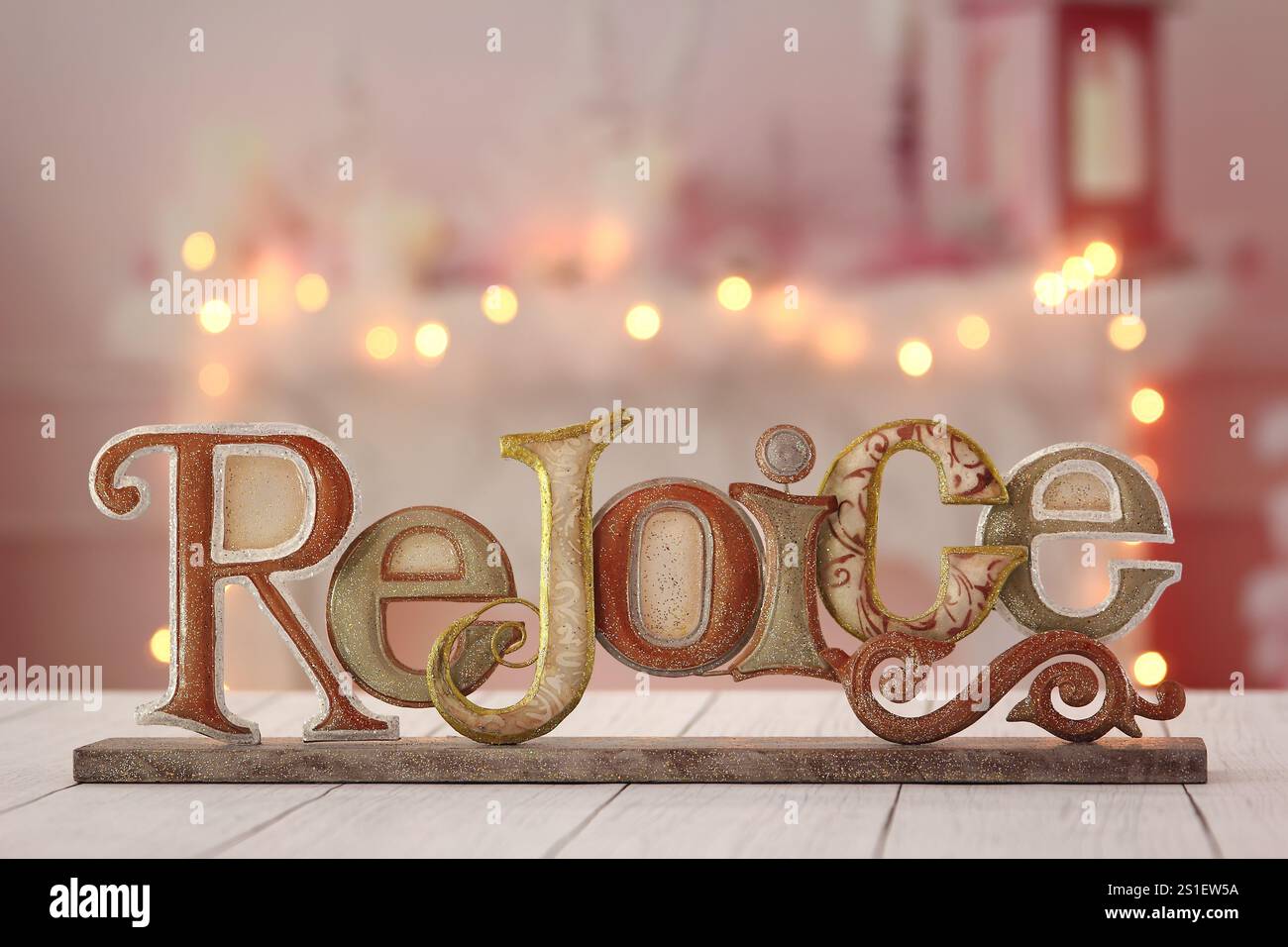 Rejoice letters in front of a fireplace with Christmas lights Stock ...