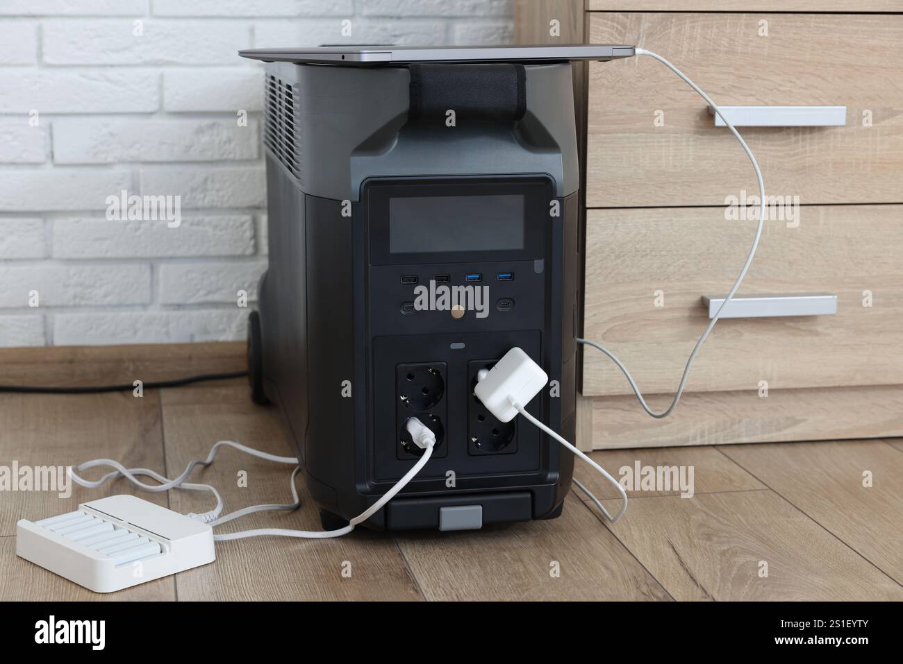 Modern portable power station, charging attached devices indoors Stock ...