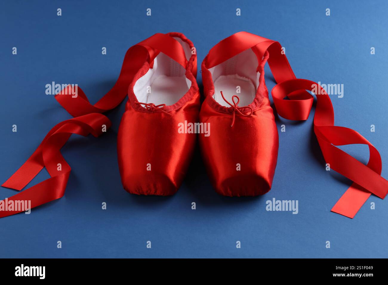 Pair of beautiful red pointe shoes on blue background Stock Photo - Alamy