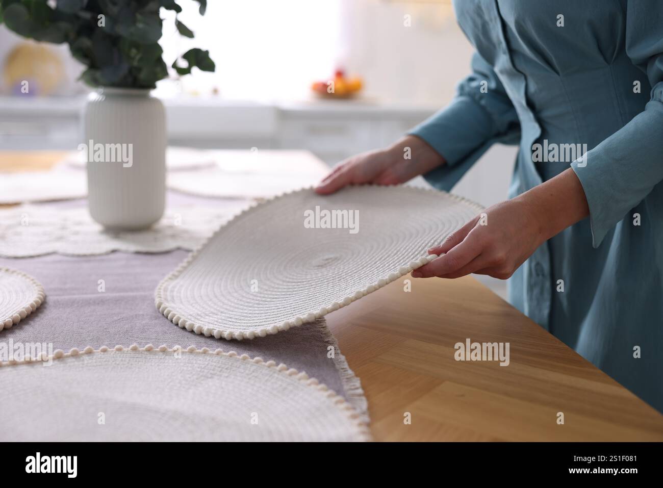 Woman setting table for dinner at home, closeup Stock Photo - Alamy