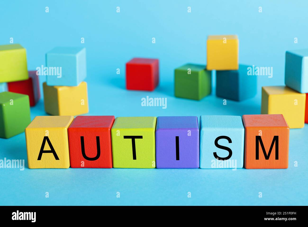 Word Autism made of colorful cubes on light blue background Stock Photo ...
