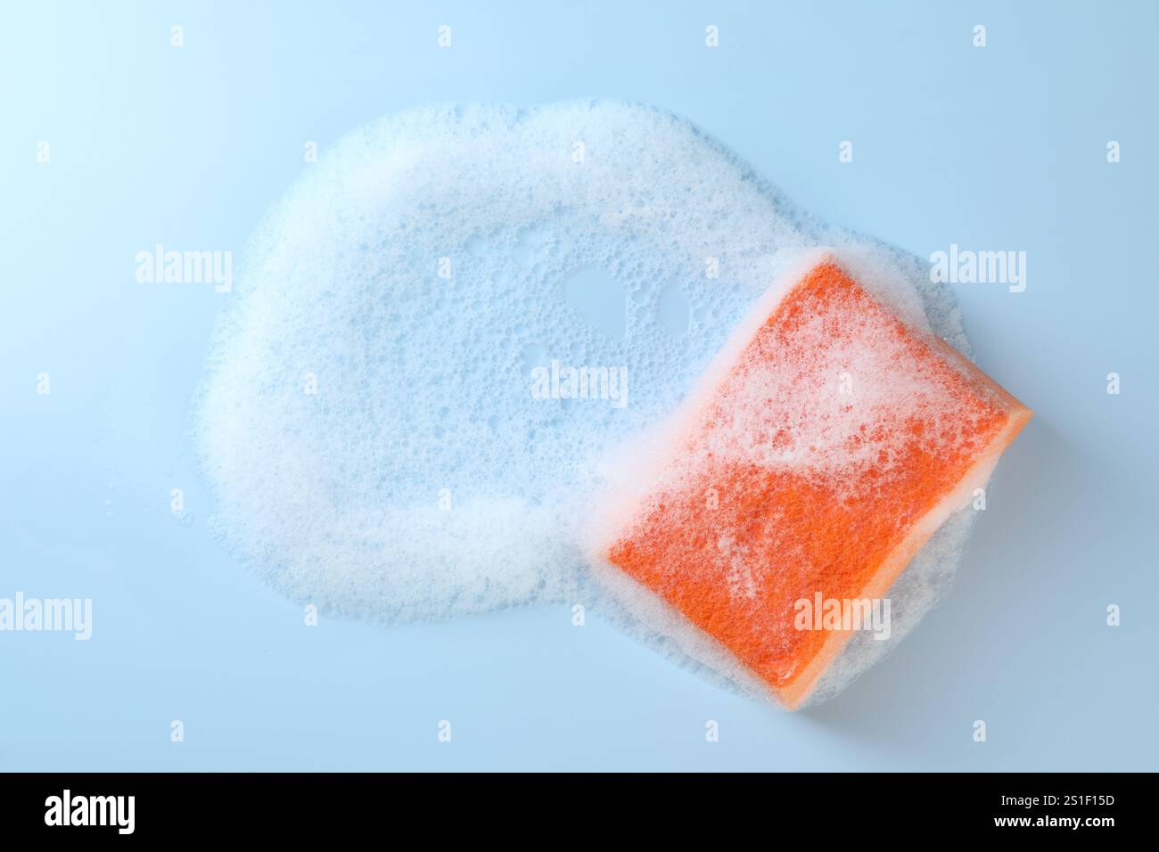 One sponge with foam on light blue background, top view Stock Photo - Alamy
