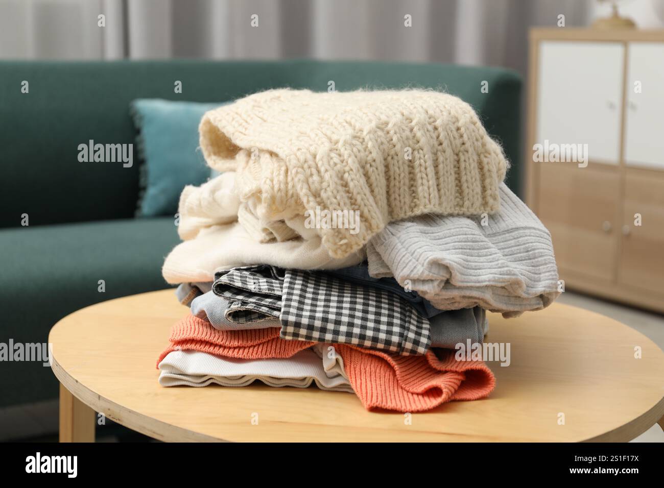 Stack of different used clothes on coffee table indoors, closeup Stock ...