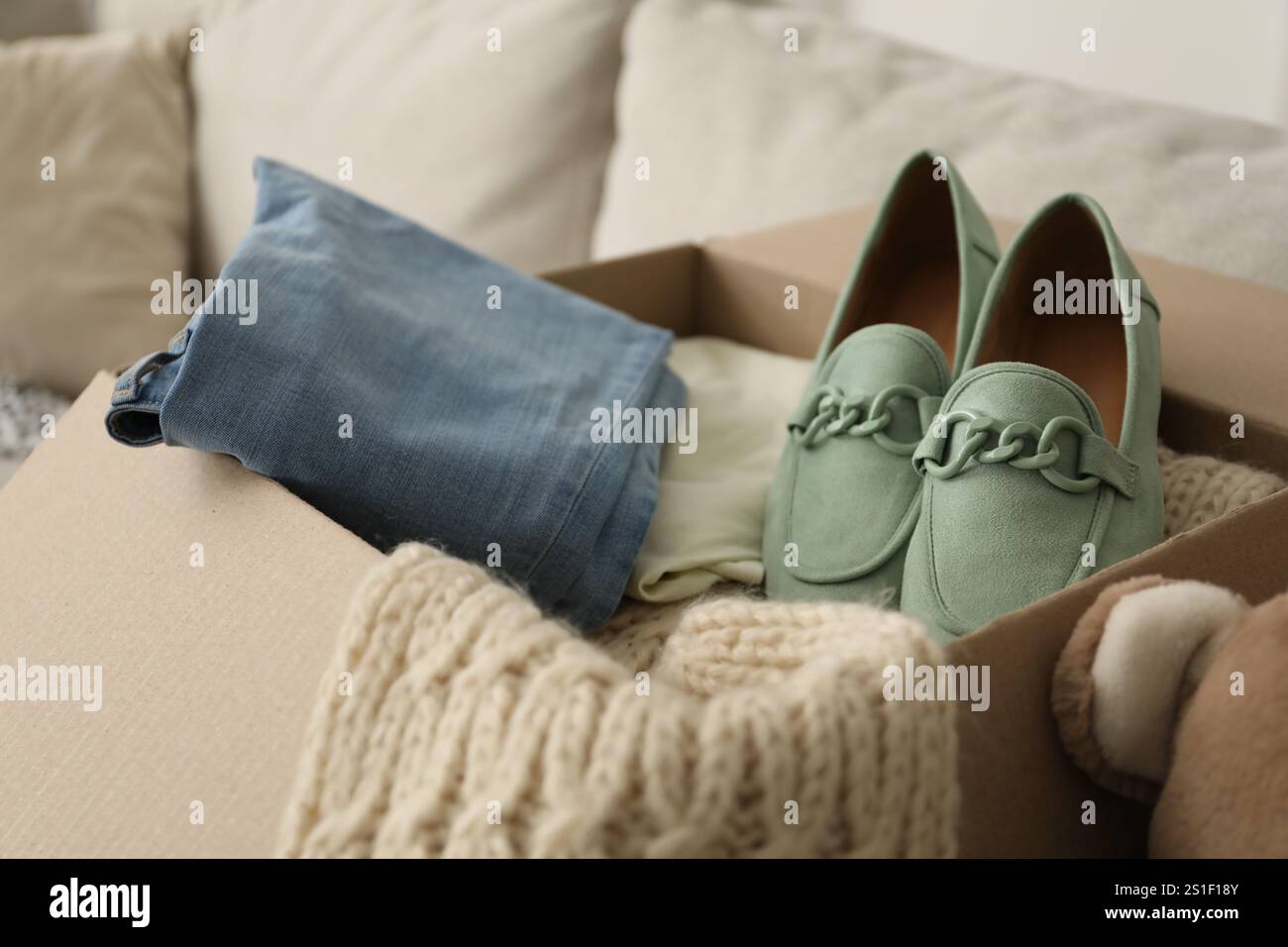 Used clothes in box indoors, closeup. Reuse and donation Stock Photo ...