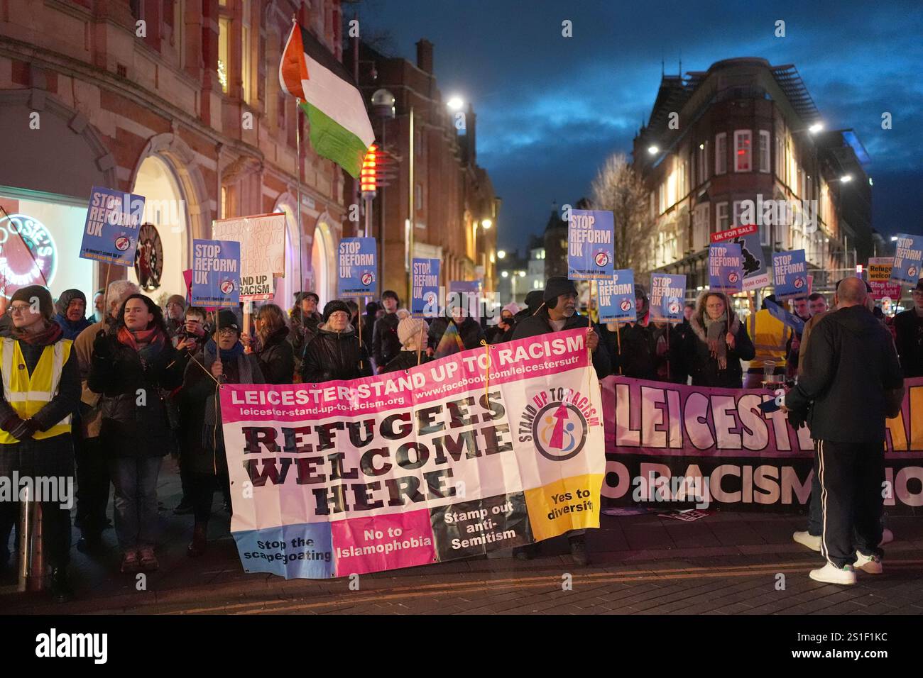People hold a protest outside the Reform UK East Midlands Conference at ...