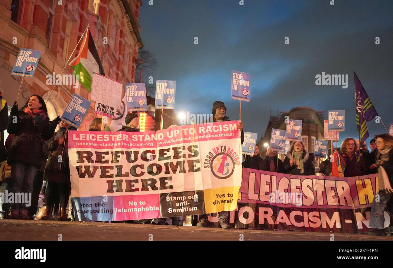 People hold a protest outside the Reform UK East Midlands Conference at ...