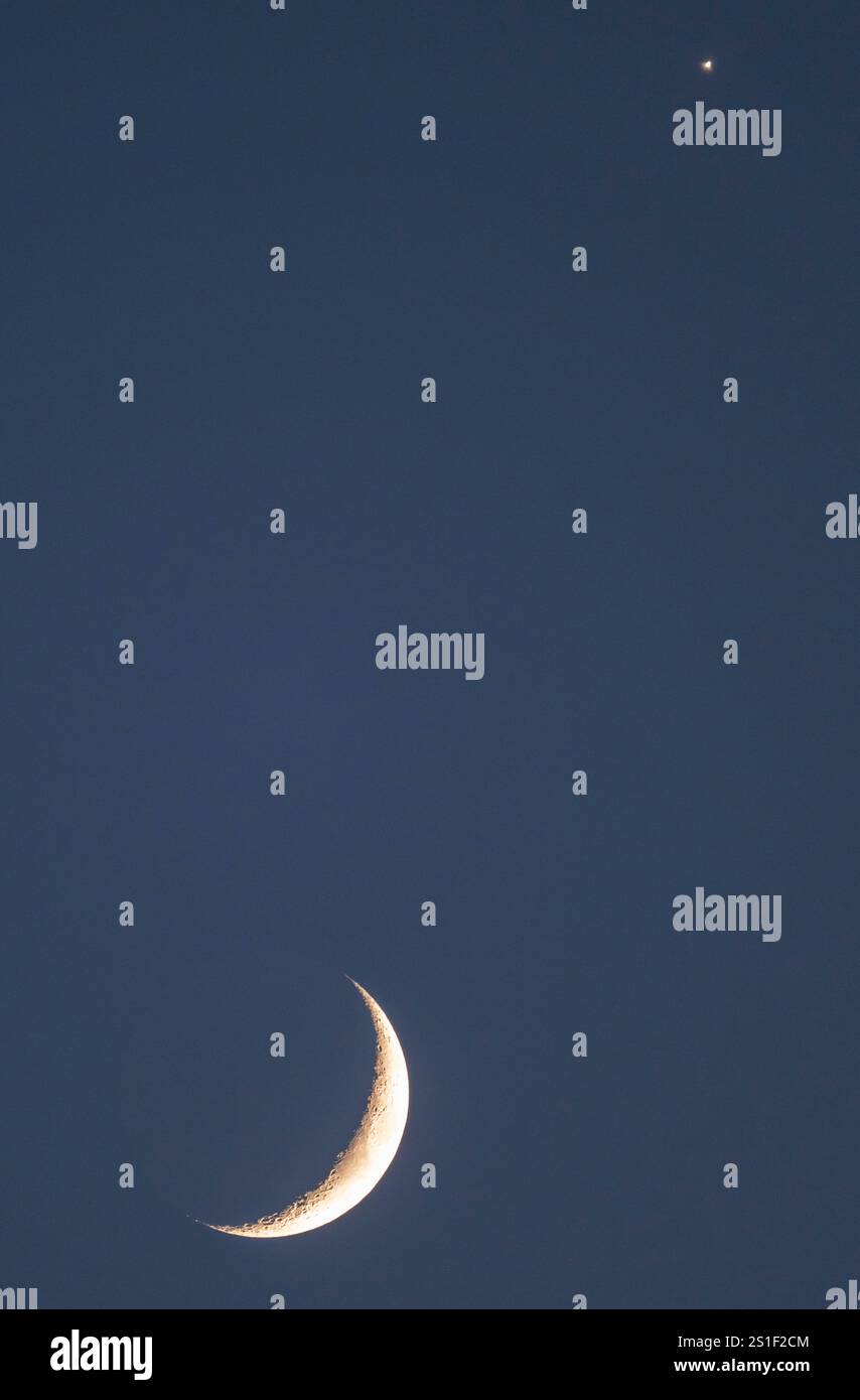 London, UK. 3rd Jan, 2024. The crescent Moon appears close to and below ...