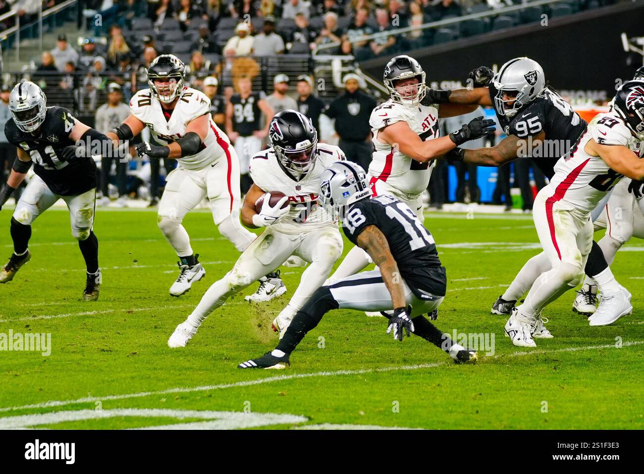Bijan Robinson #7 of the Atlanta Falcons tries to get around Jack Jones ...