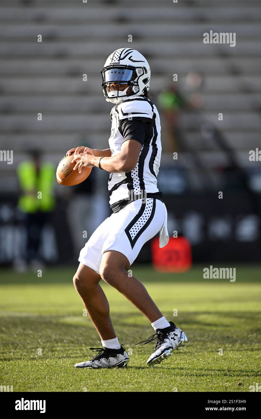 Team Unstoppable quarterback KJ Lacey (9) warms up before the Under ...