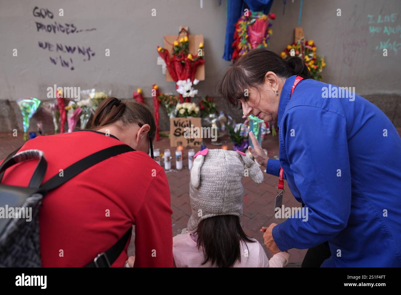 Allyson Tomkins, right, prays with Emily Lara, 5, center, and her ...