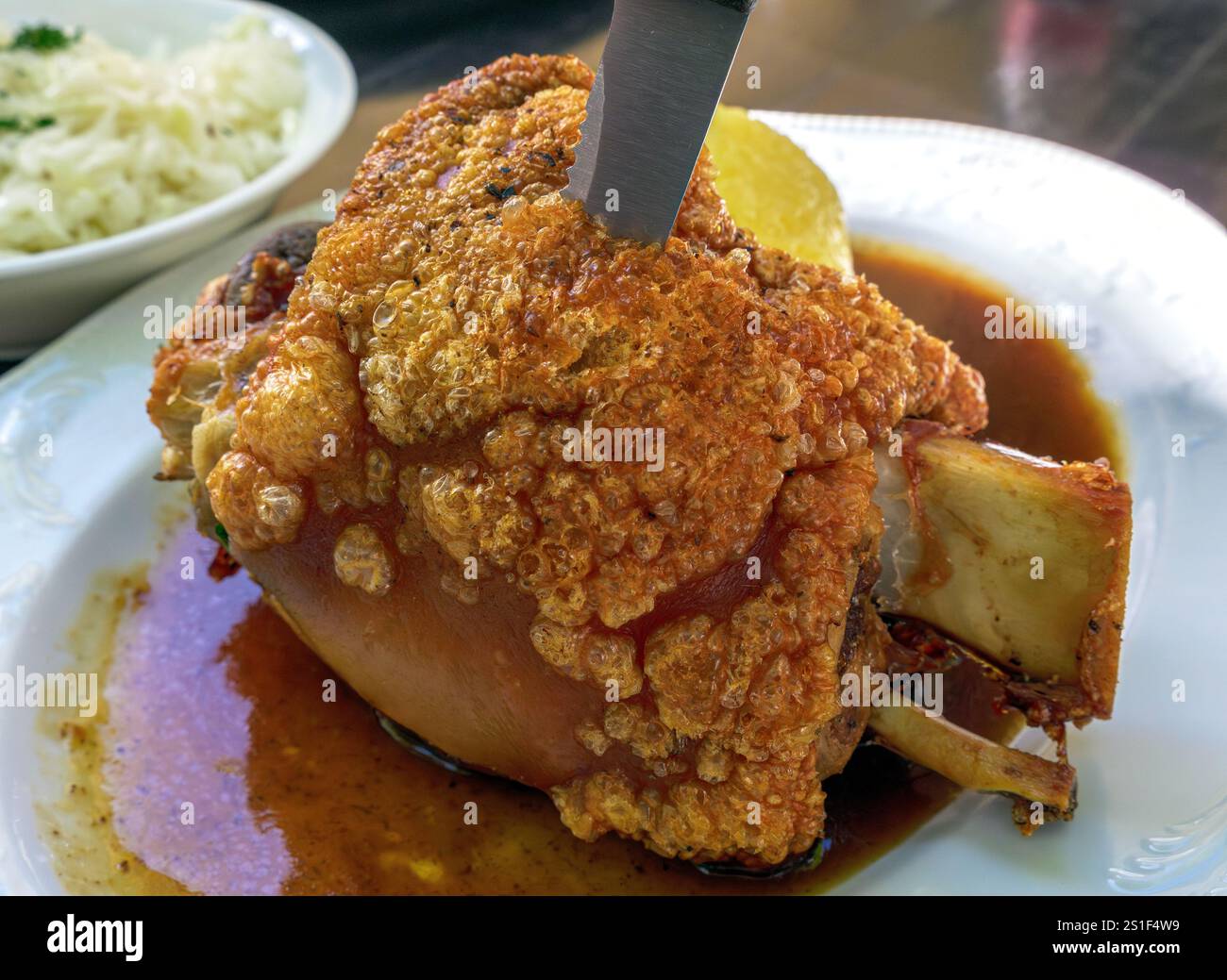 Crispy fried Bavarian pork knuckle in a beer garden, Bavaria, Germany ...