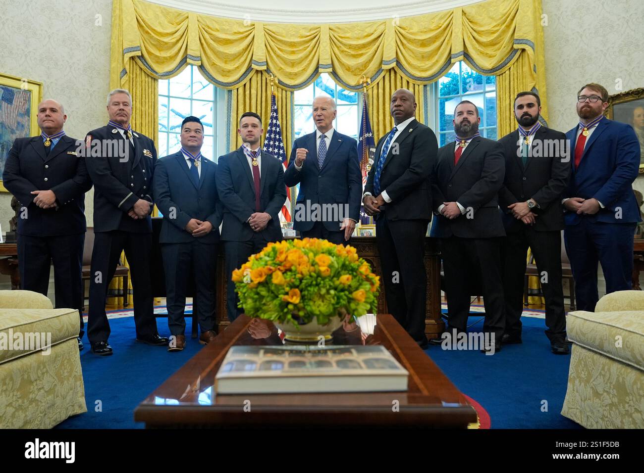 President Joe Biden, center, poses for a photo with Medal of Valor ...