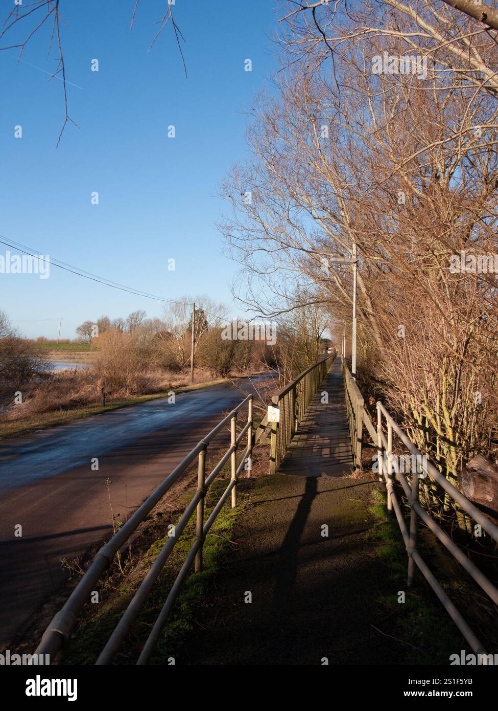 Raised walkway alongside a stretch of road prone to flooding at Sutton ...