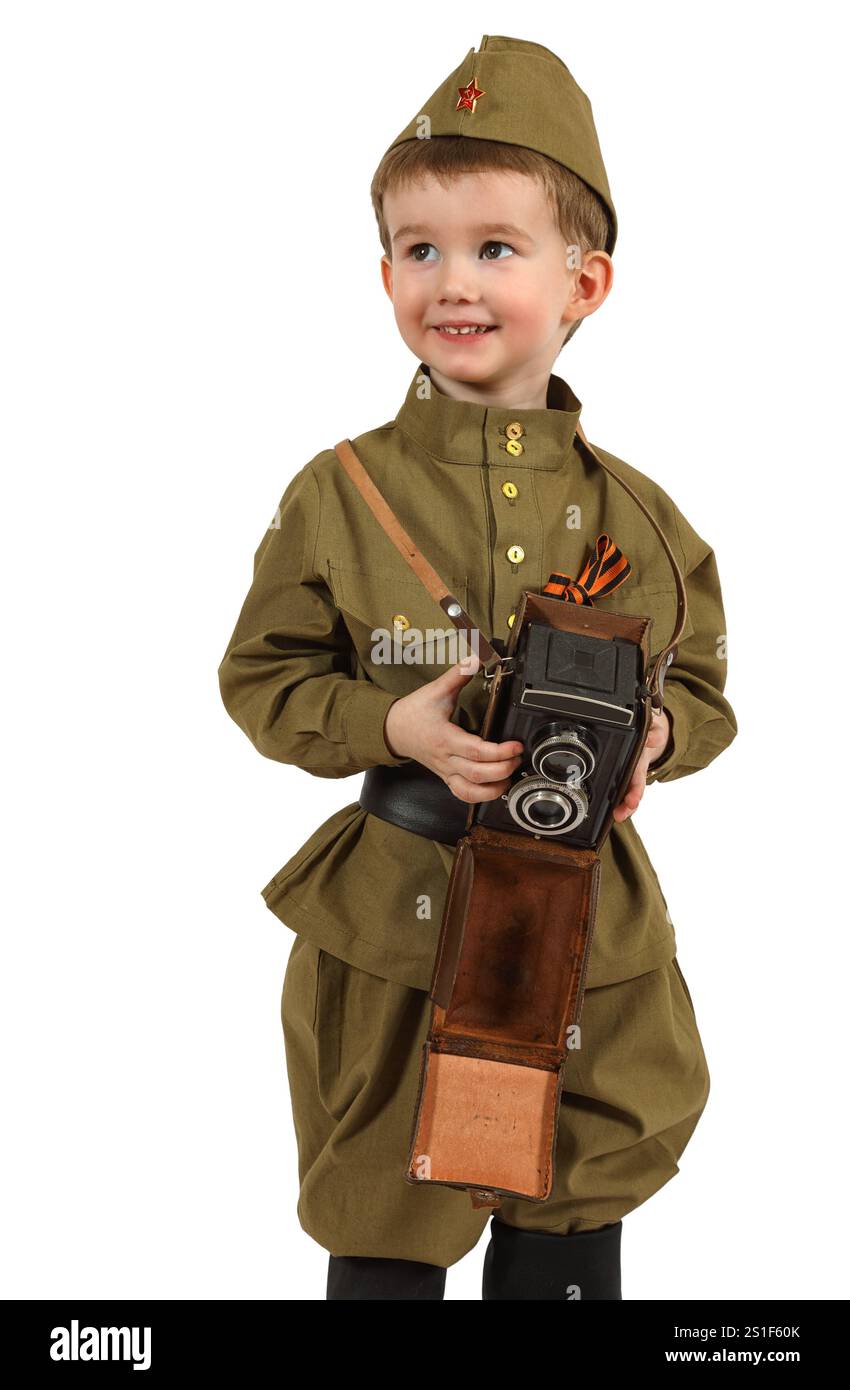 The little cute boy dressed in the old-fashioned Soviet military ...