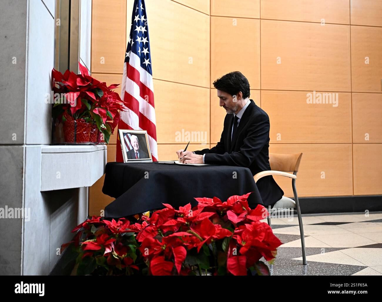 Prime Minister Justin Trudeau signs a book of condolences for former U ...