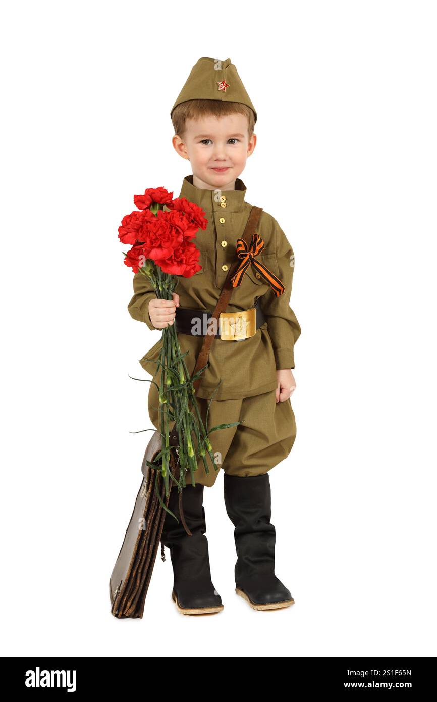 The little cute boy in the old-fashioned Soviet military uniform with a ...
